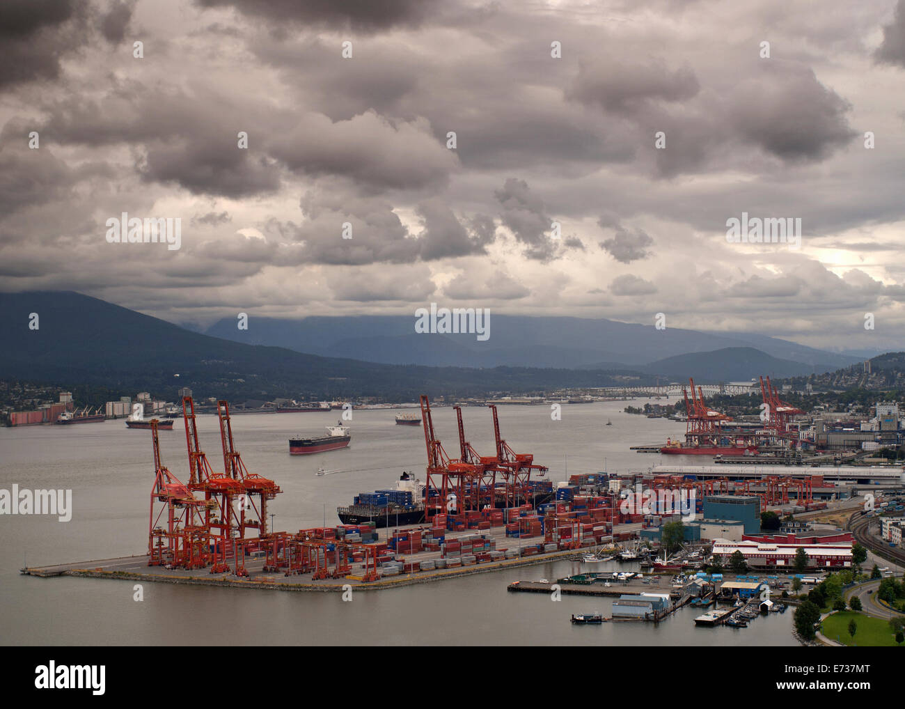 Wide shot over a large part of Vancouver harbor with container terminal ...