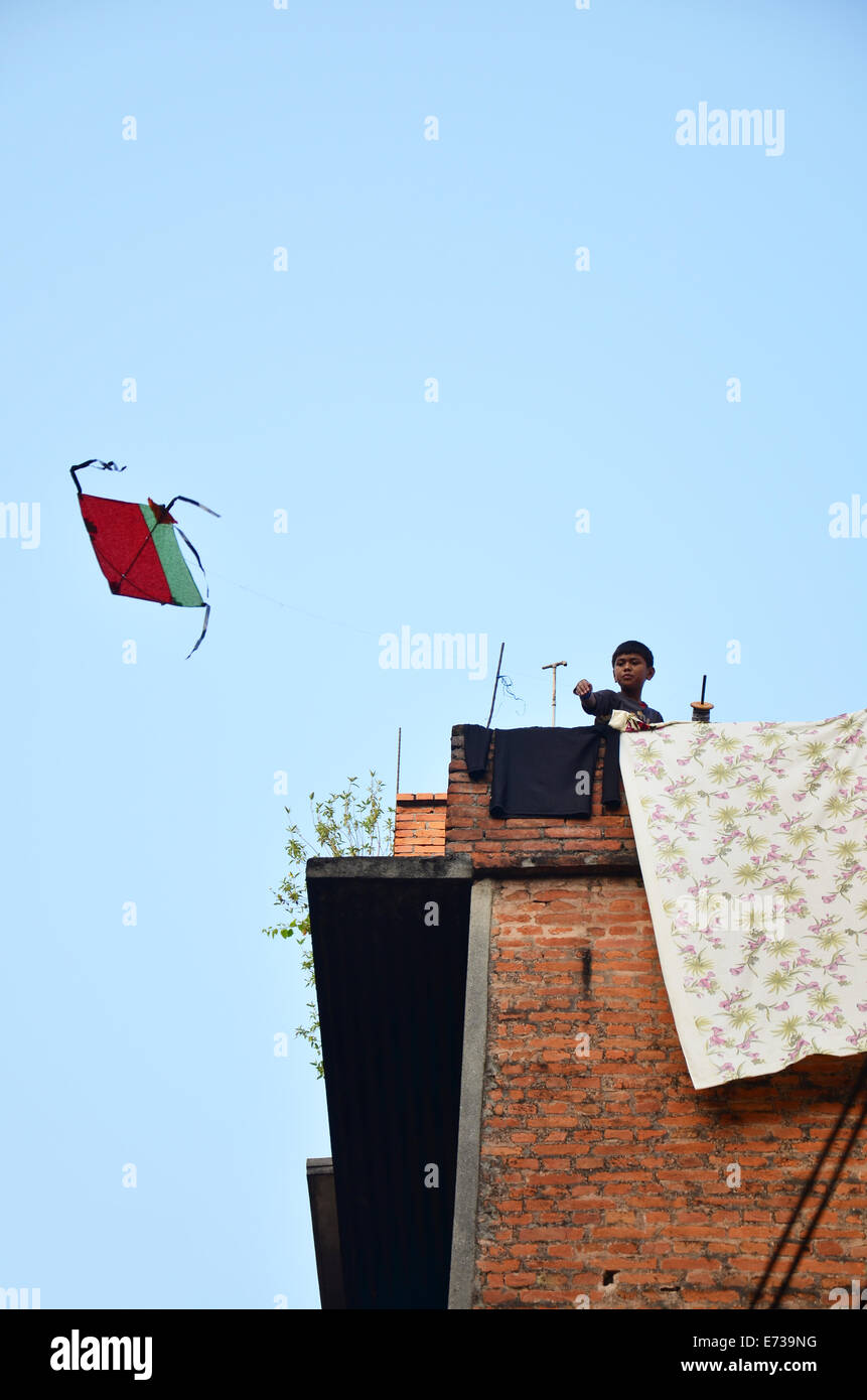 Child Nepalese playing kate at town on November 2, 2013 in Patan Nepal ...