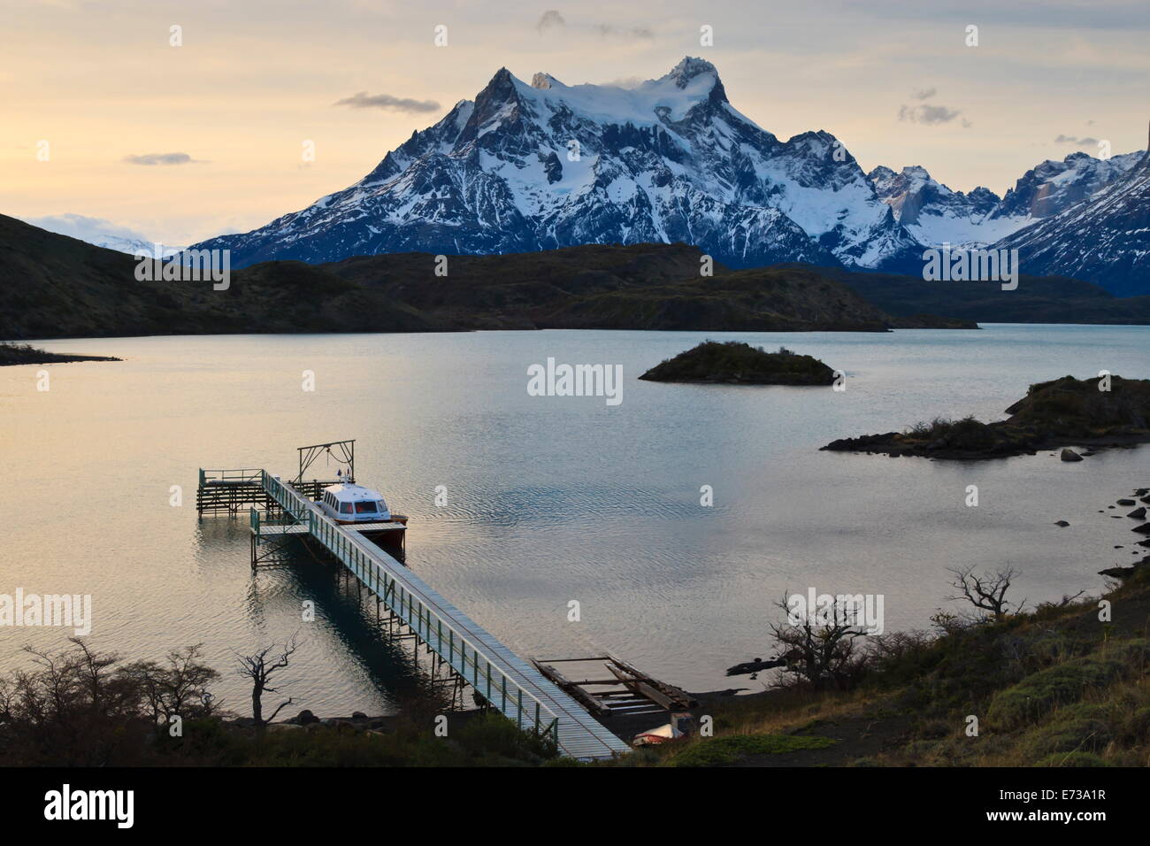 Lago Pehoe boat and dock with the Cordillera del Paine at sunset ...