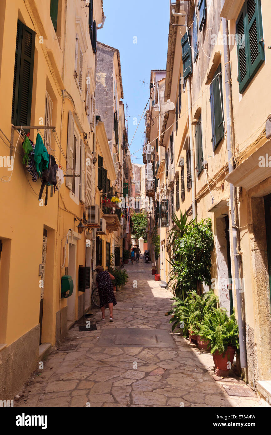 Narrow street with lady sweeping, Old Town, Corfu Town, UNESCO Site ...