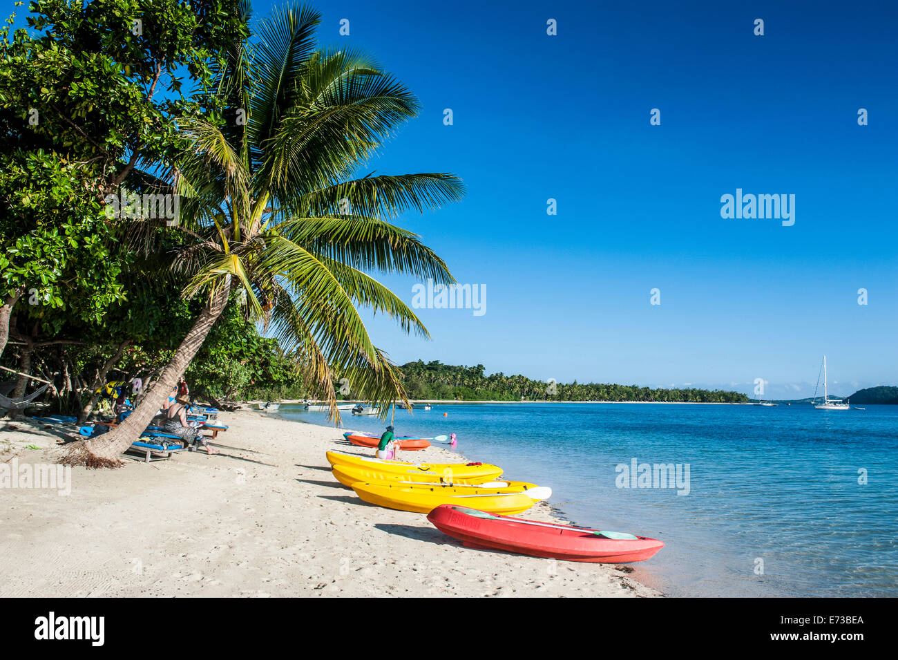 Kayaks on the white sand beach of Nanuya Lailai island, the blue lagoon ...