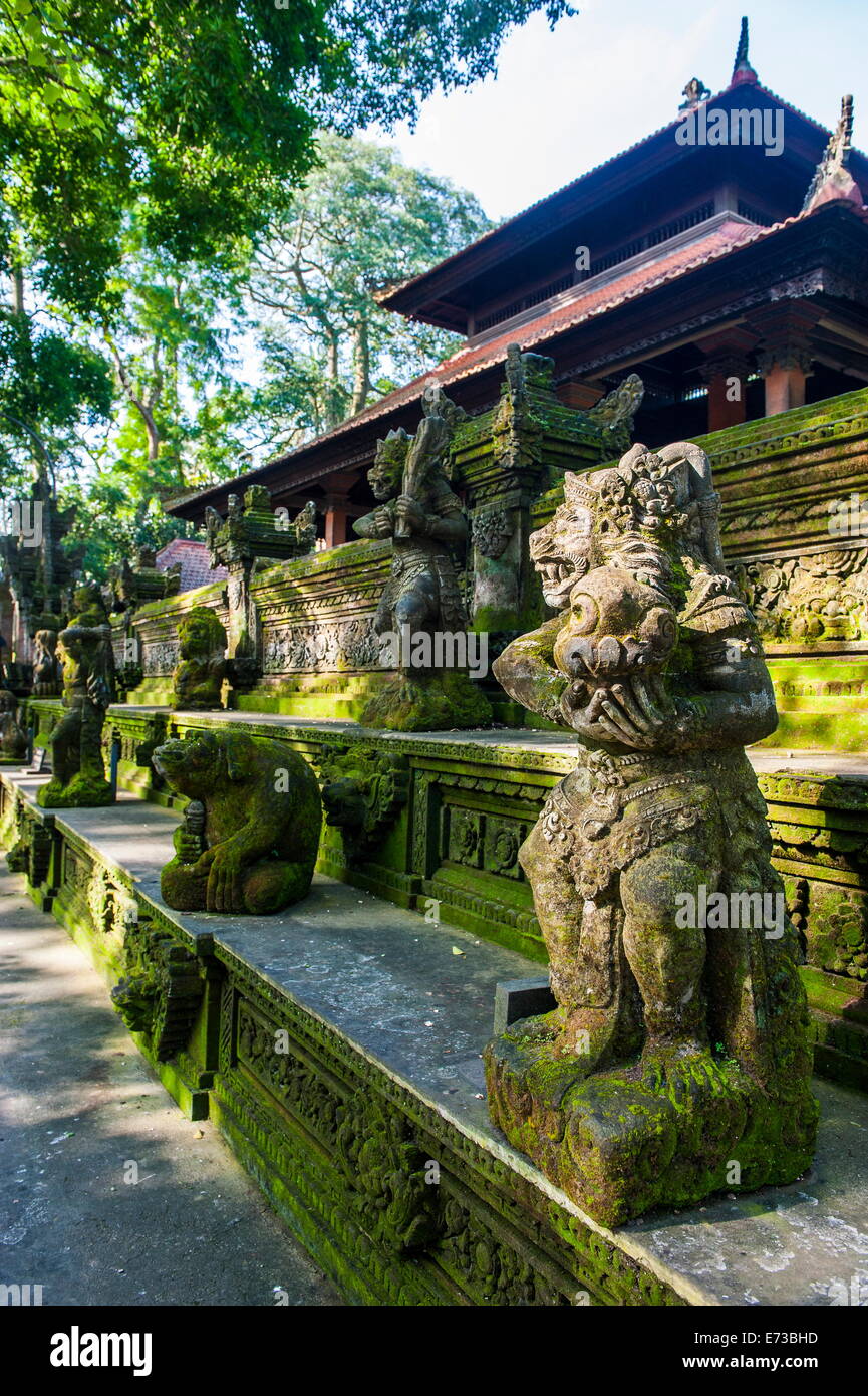 Overgrown statues in a temple in the Monkey Forest, Ubud, Bali ...
