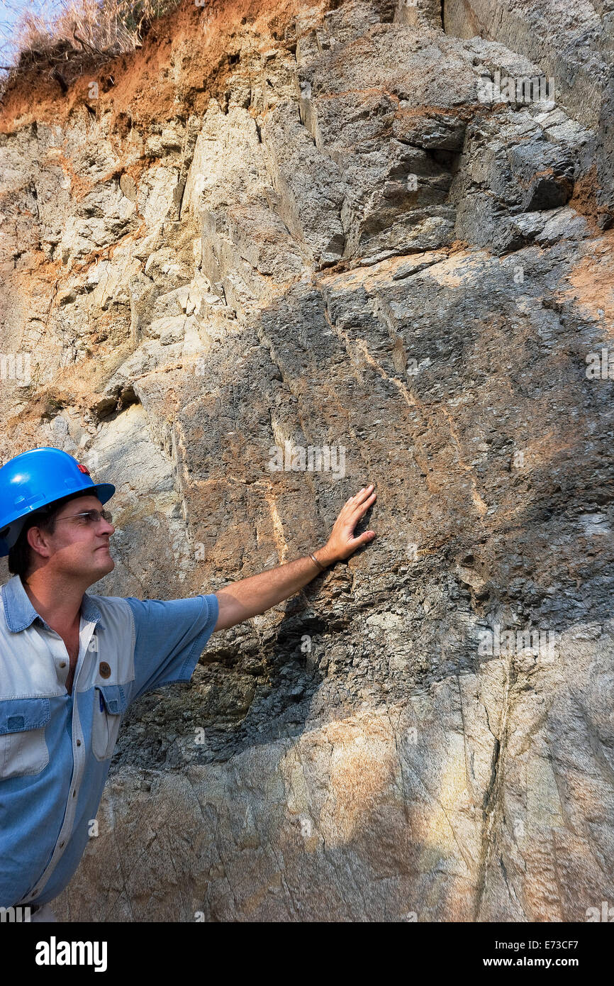 Mine geologist shows exposed rock reef with UG2 or upper group layer 2 ...