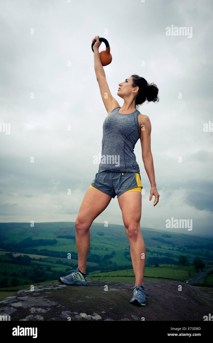 Female exercising outdoor with kettlebells Stock Photo - Alamy
