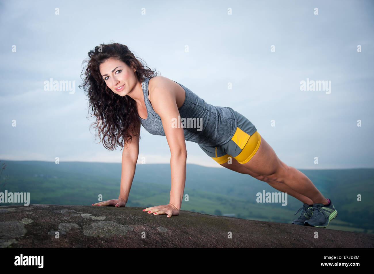 Woman practicing outdoor exercise Stock Photo - Alamy