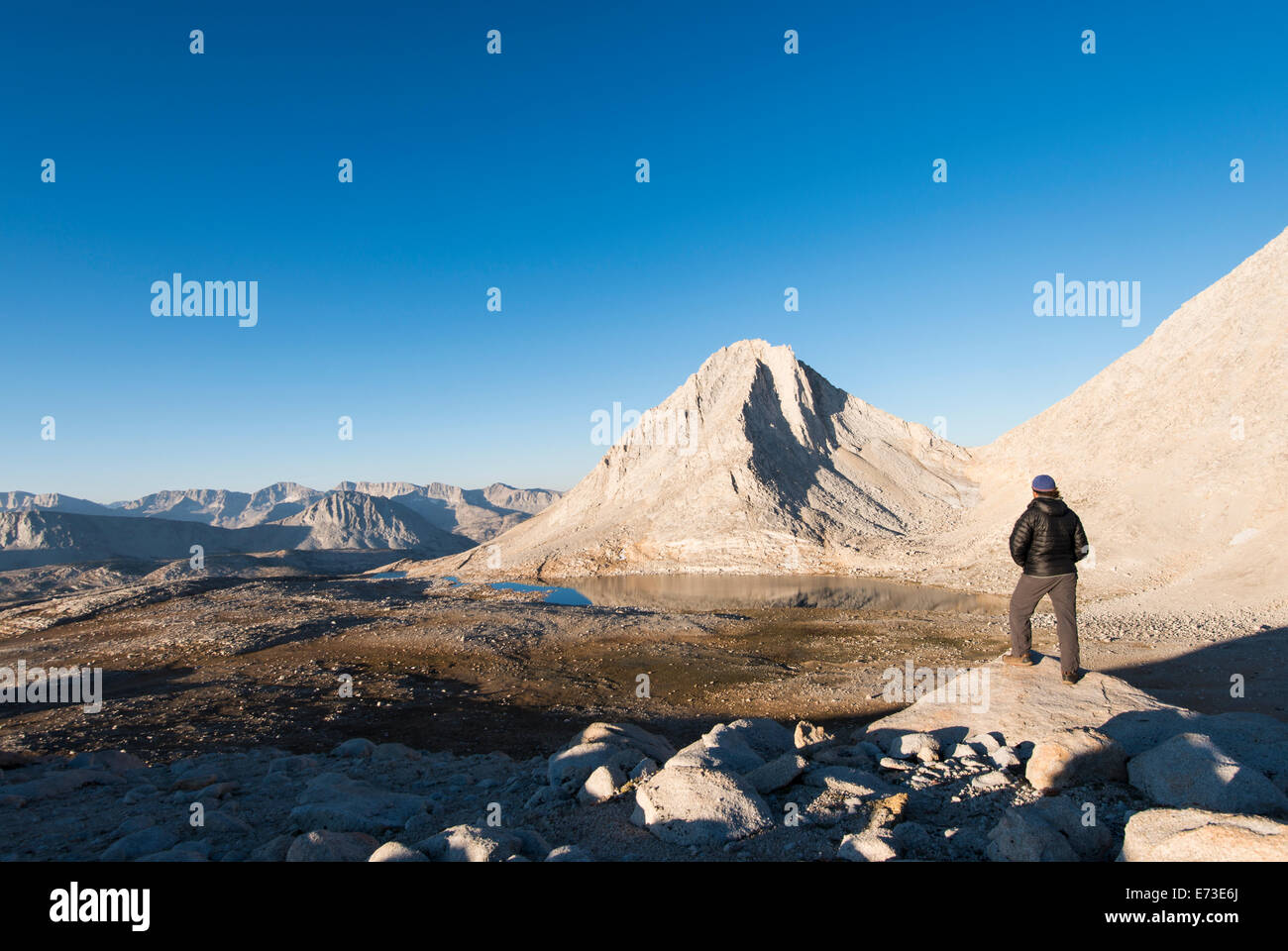 Hiker looking over Royce Lakes and Merriam Peak, High Sierra Stock ...