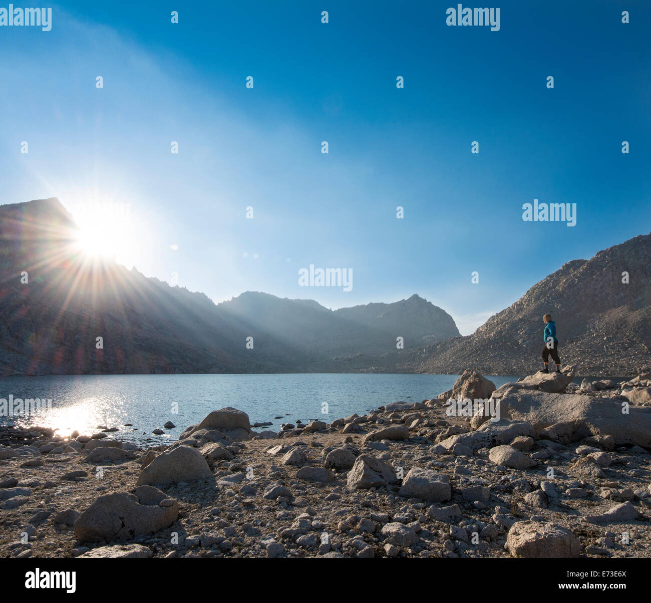 Sunstar and hiker looking over Royce Lakes, High Sierra Stock Photo - Alamy