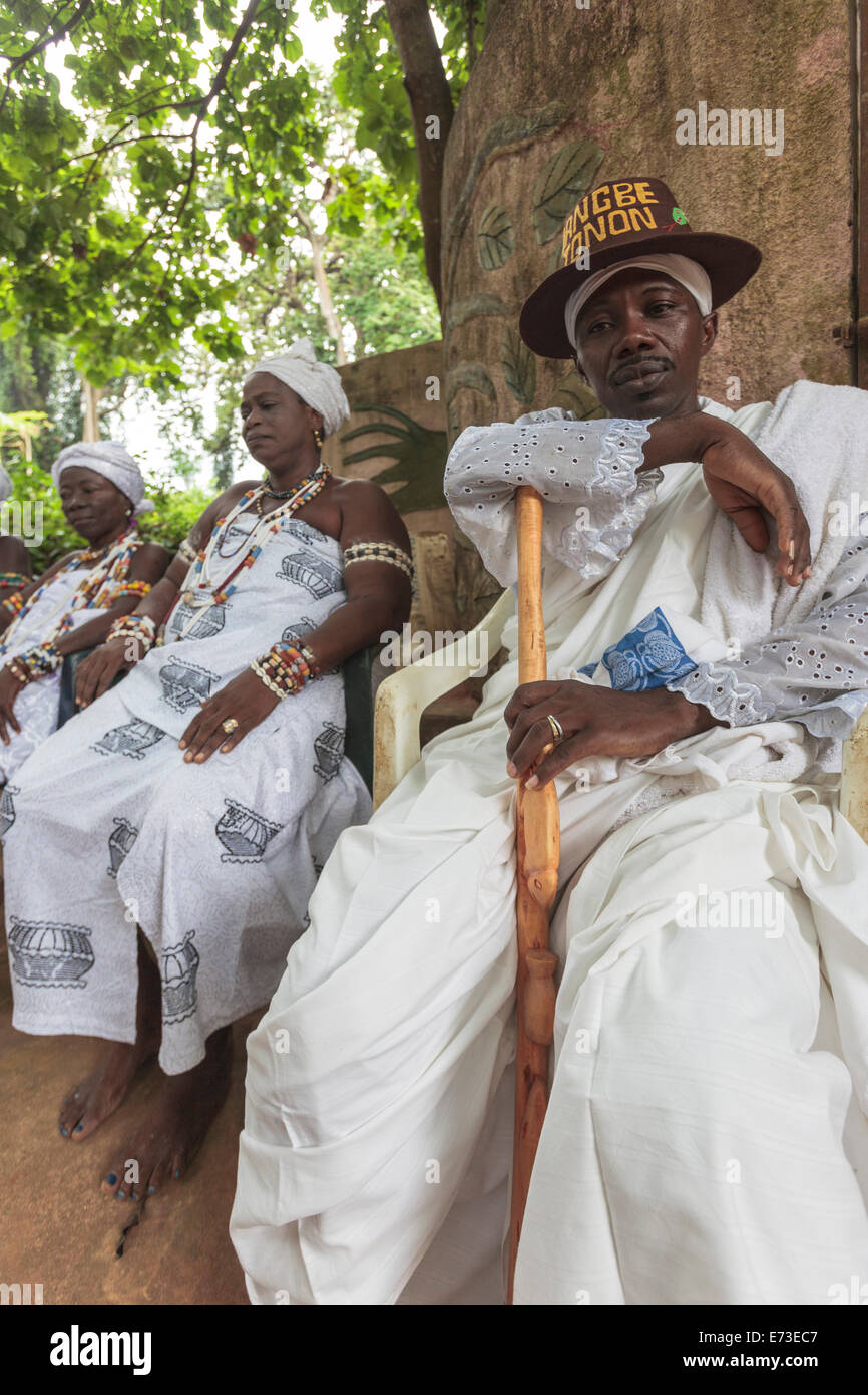 Africa, Benin, Ouidah. Priestesses and priest leaning on symbolic staff ...