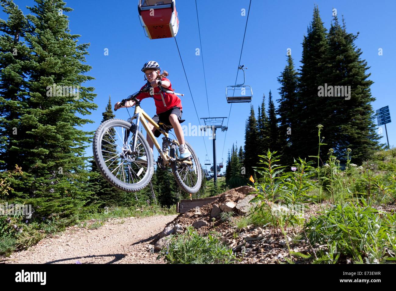 A teenage girl rides her mountain bike in Whitefish, Montana Stock ...