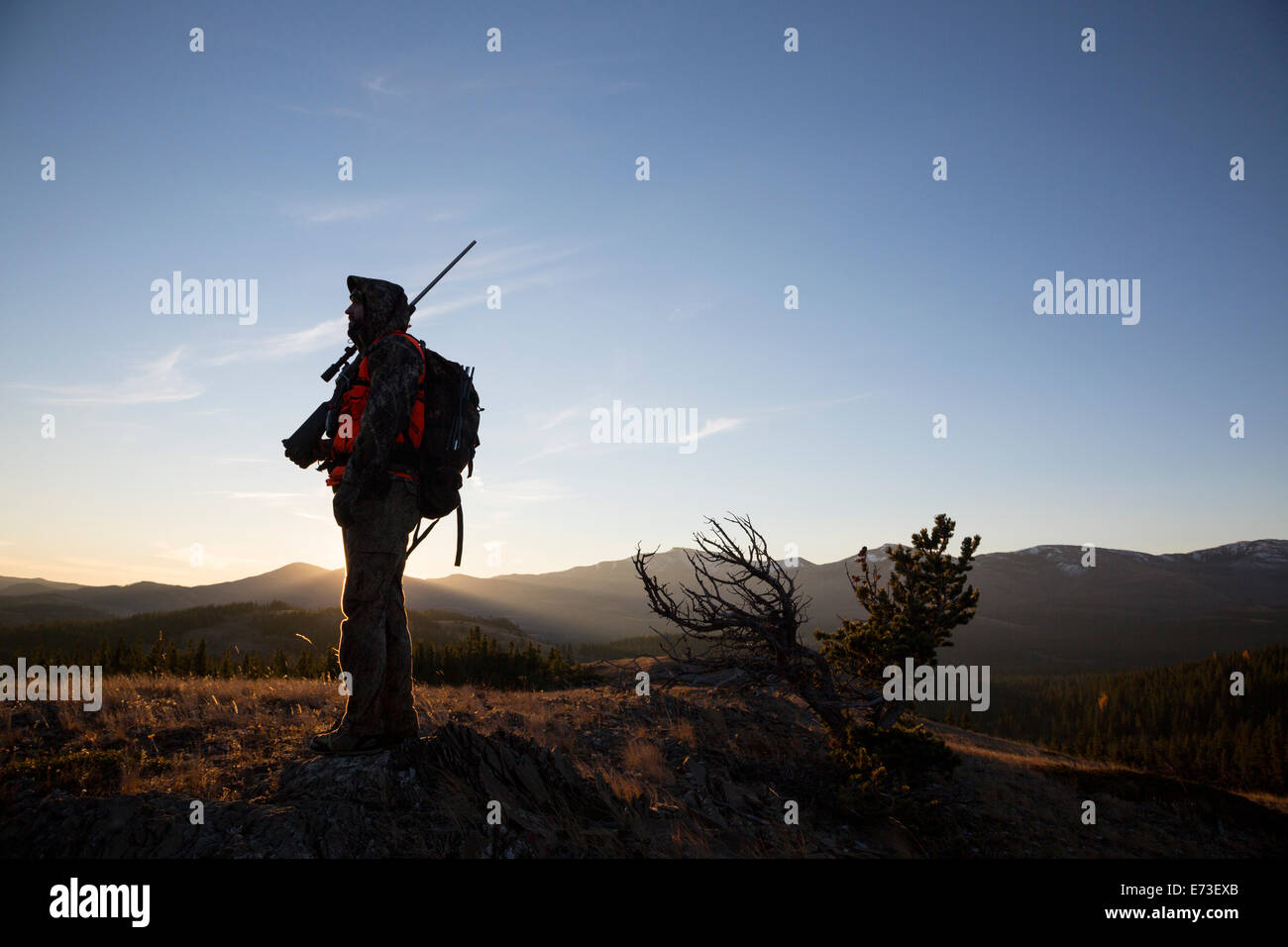A backlit male hunter at sunrise Stock Photo - Alamy