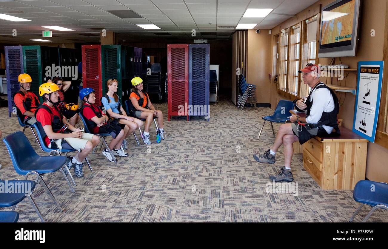 A group at a zip line safety meeting Stock Photo - Alamy