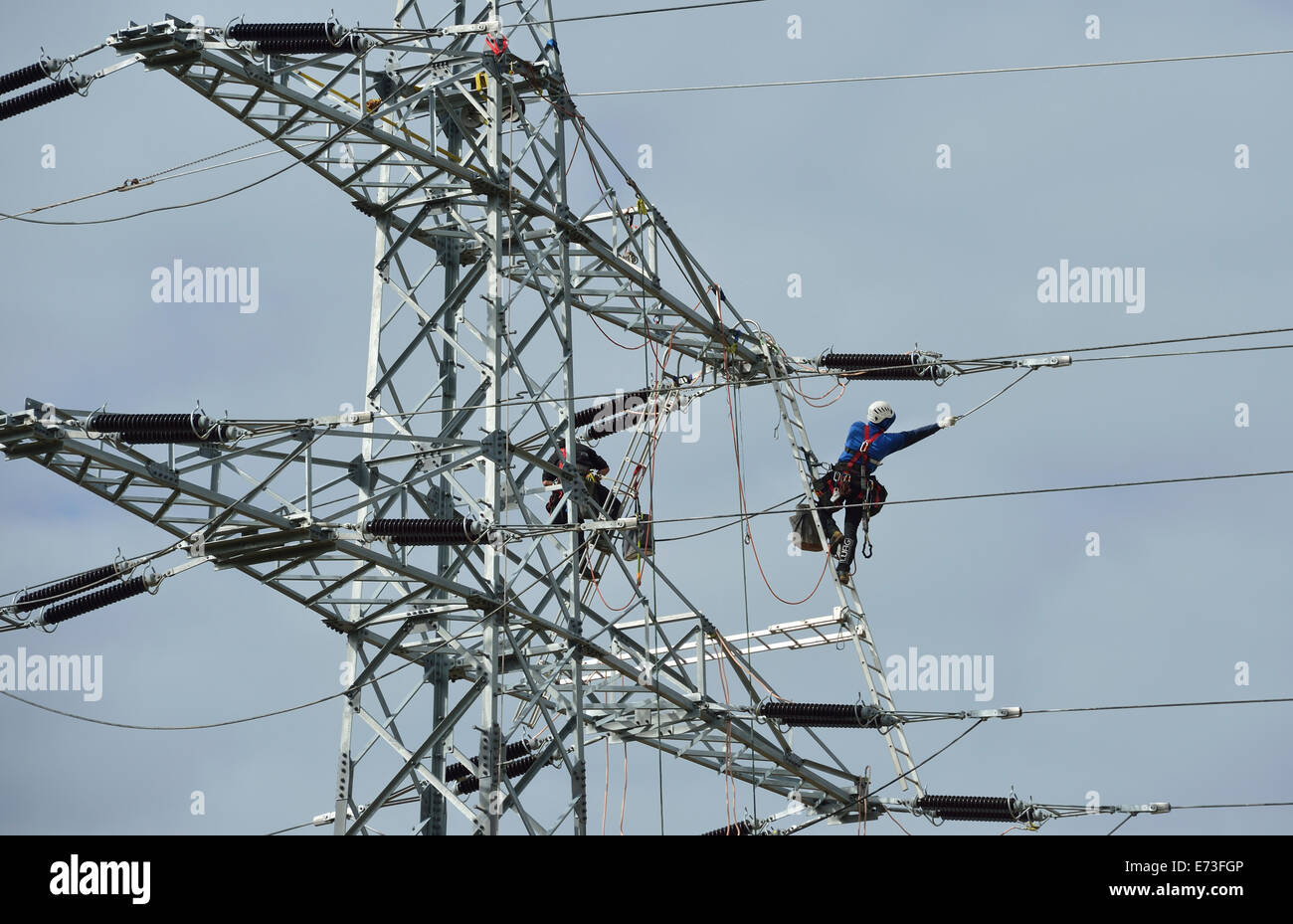 Technicians work on high voltage power lines in Ludwigsburg, Germany ...