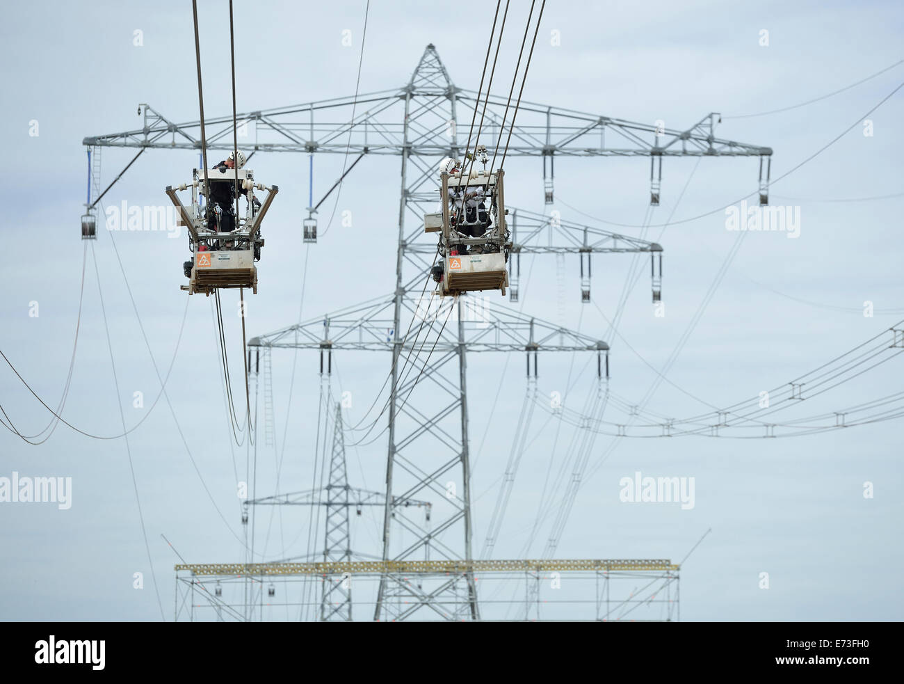 Technicians work on high voltage power lines in Ludwigsburg, Germany ...