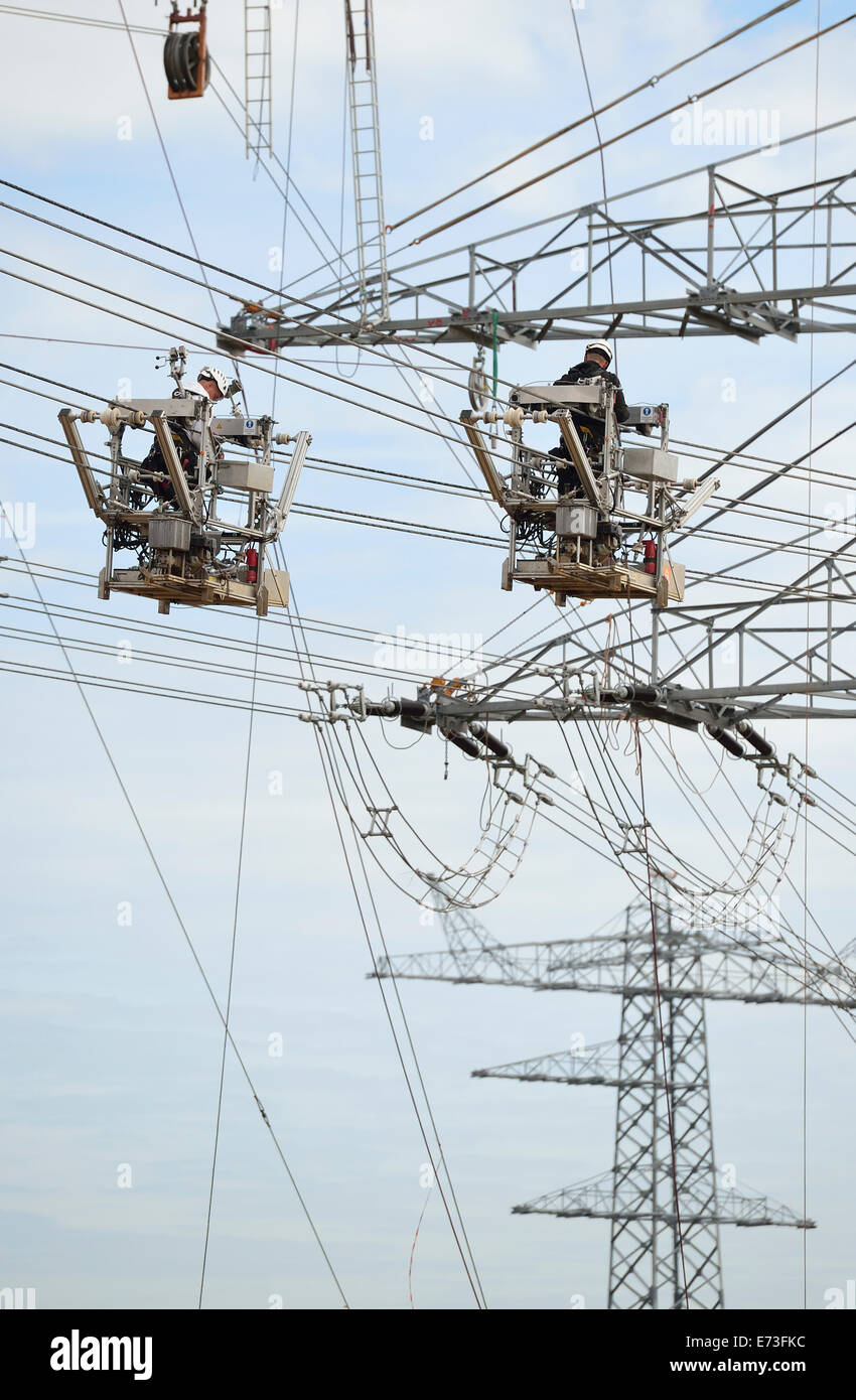 Technicians work on high voltage power lines in Ludwigsburg, Germany ...