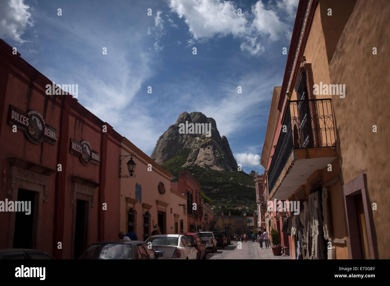 The Pena de Bernal monolithic mountain is seen from a street of San ...