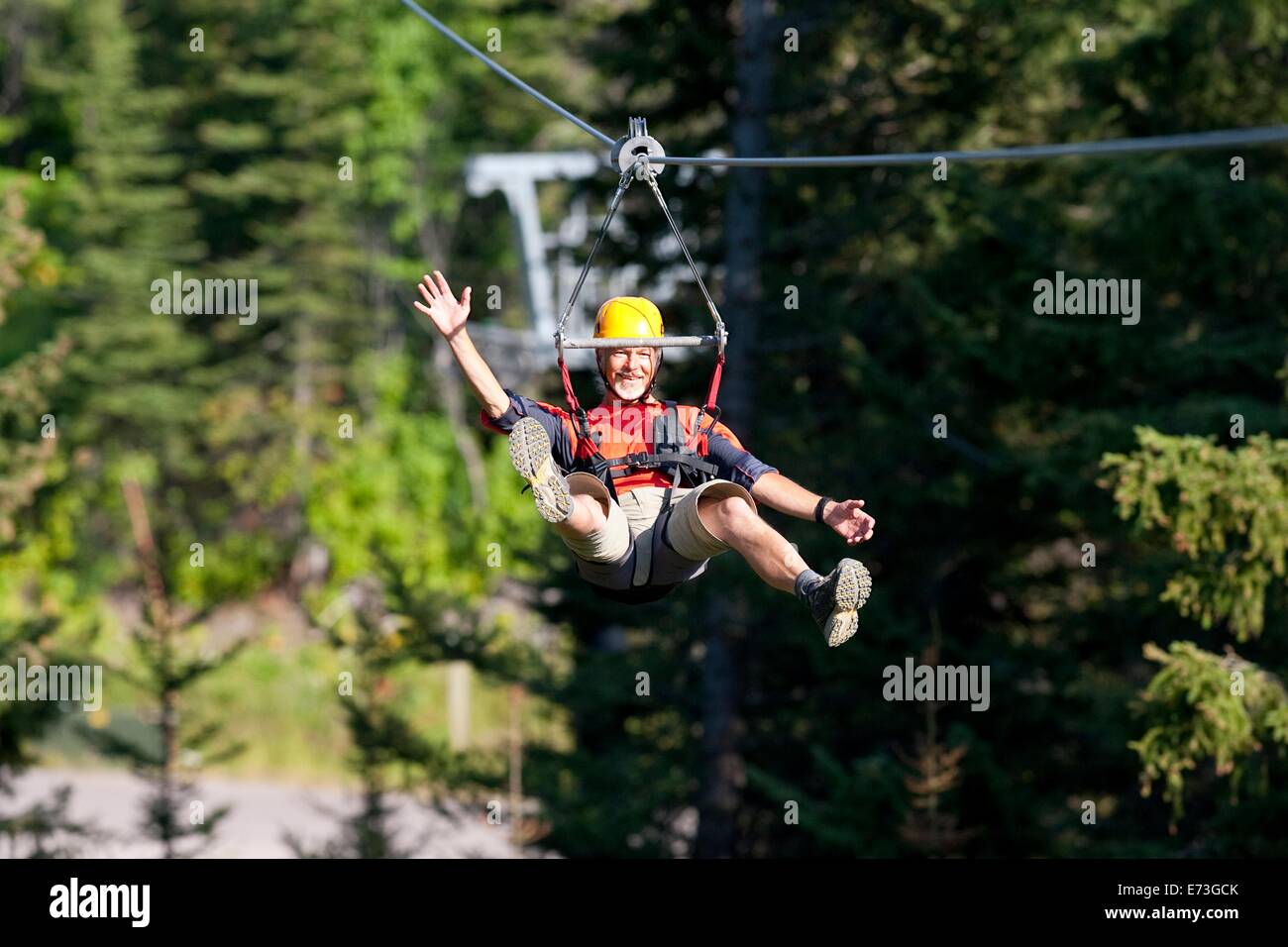 A man on a zip line in Whitefish, Montana Stock Photo - Alamy