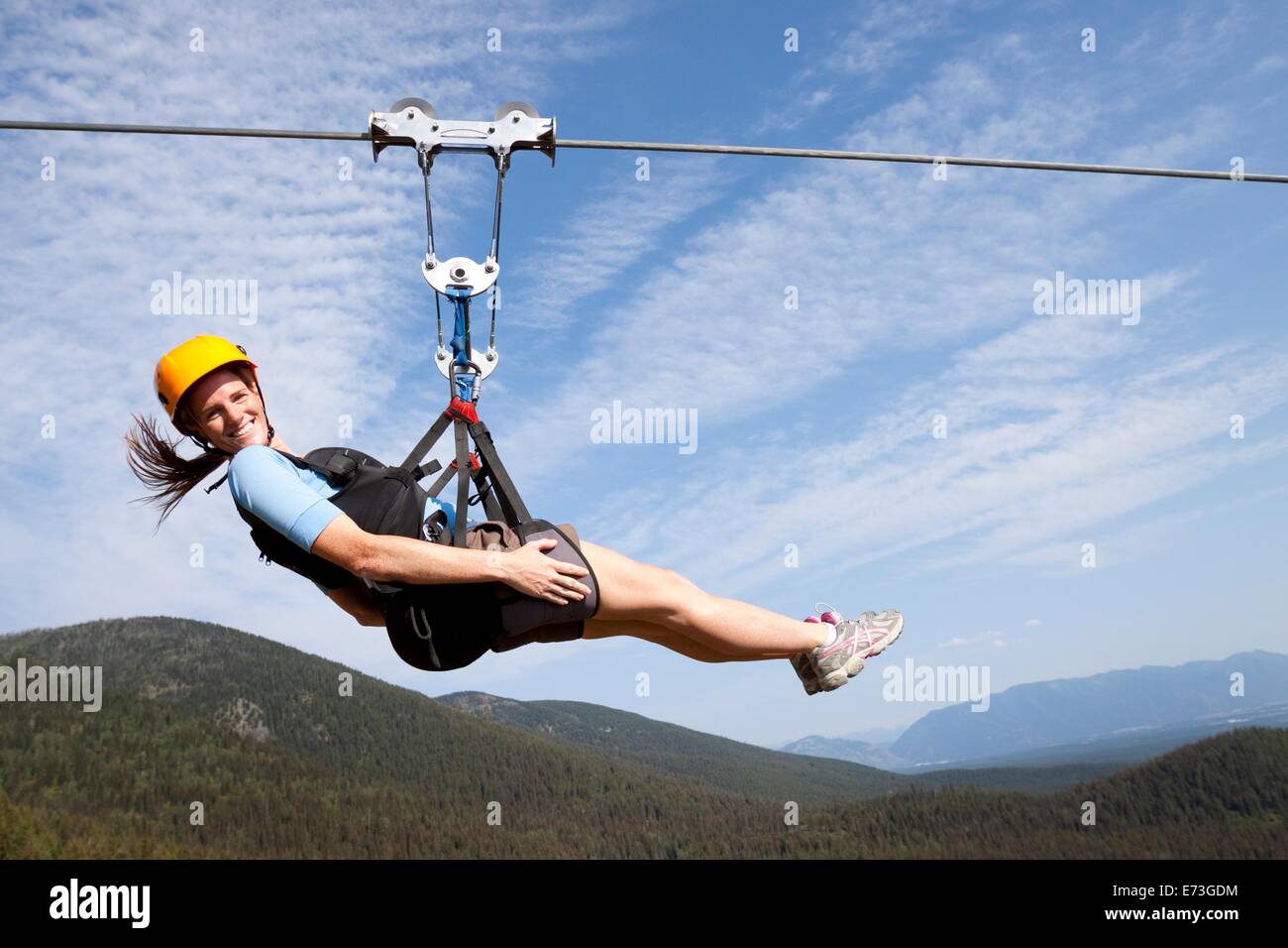 A woman on a zip line tour in Whitefish, Montana Stock Photo - Alamy