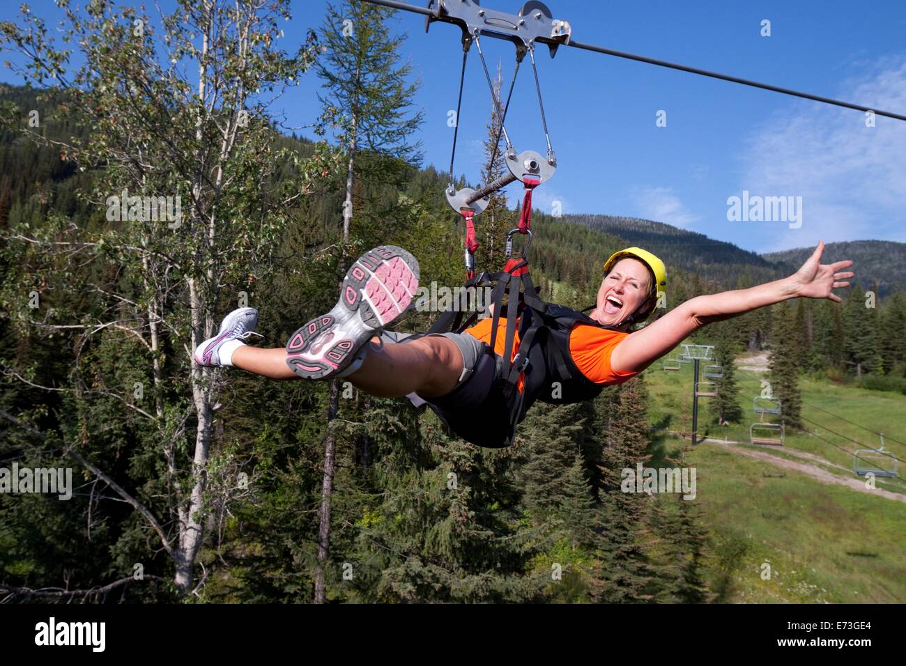 A woman on a zip line tour in Whitefish, Montana Stock Photo - Alamy