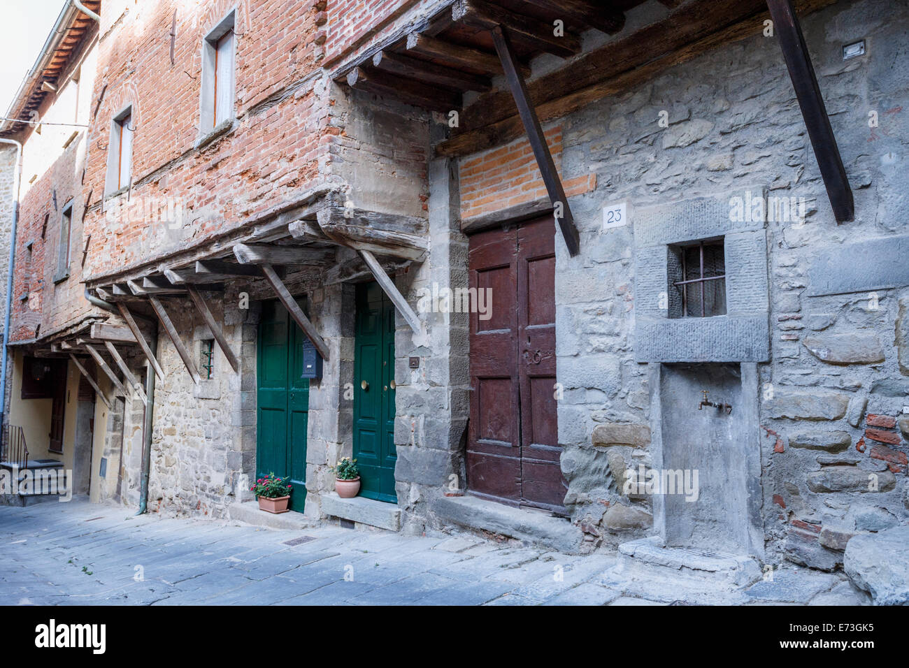 Original brick and overhanging medieval houses in Cortona, Tuscany ...