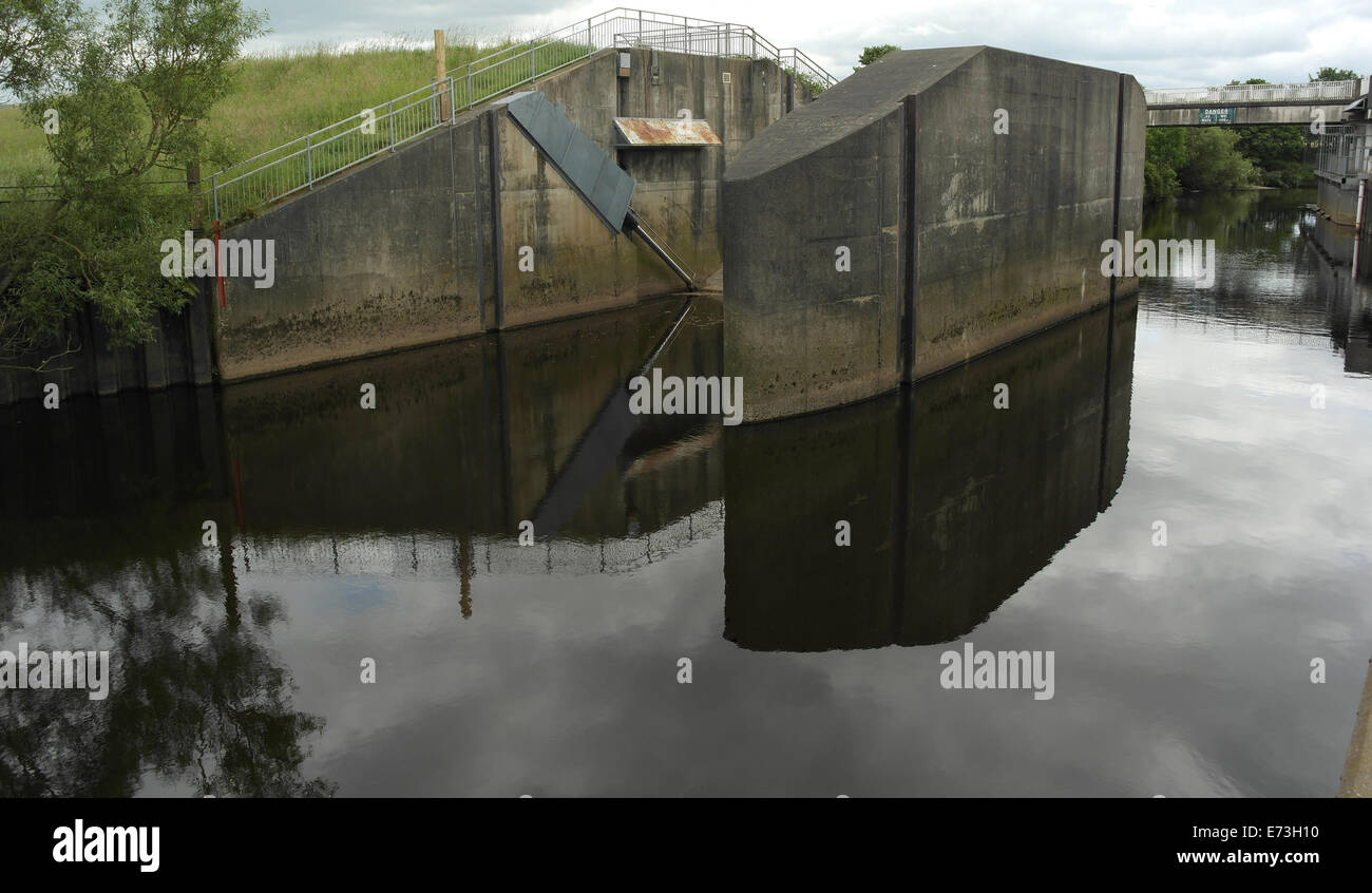 View, looking downstream, concrete flood barrier with lowered sluice ...