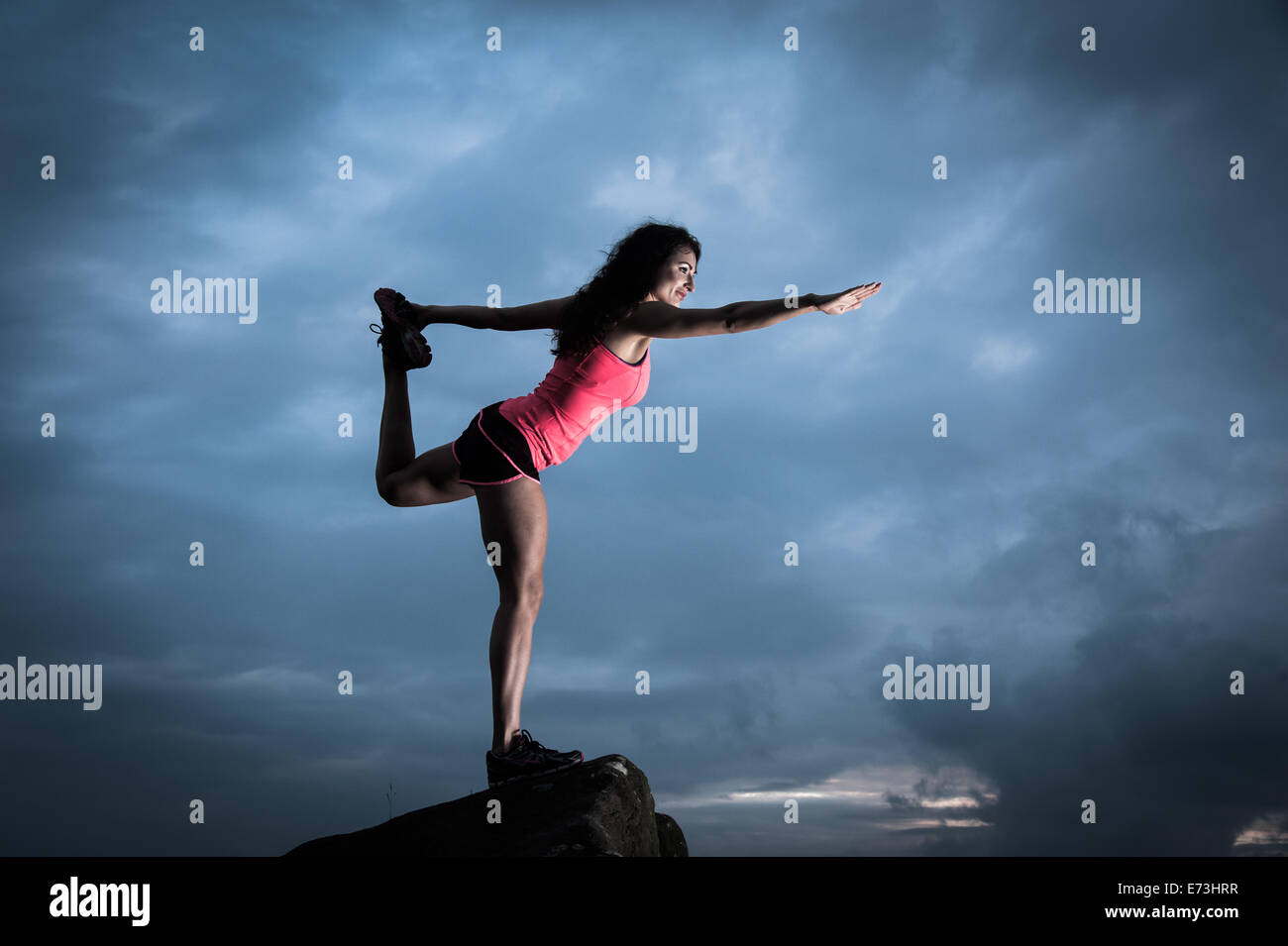 Woman performing warm up stretch Stock Photo - Alamy