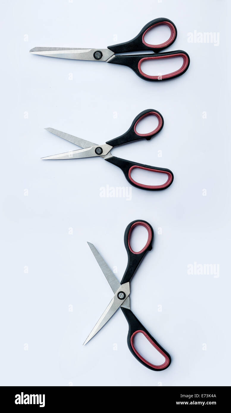 Three open pair of scissors ready to cut Stock Photo - Alamy