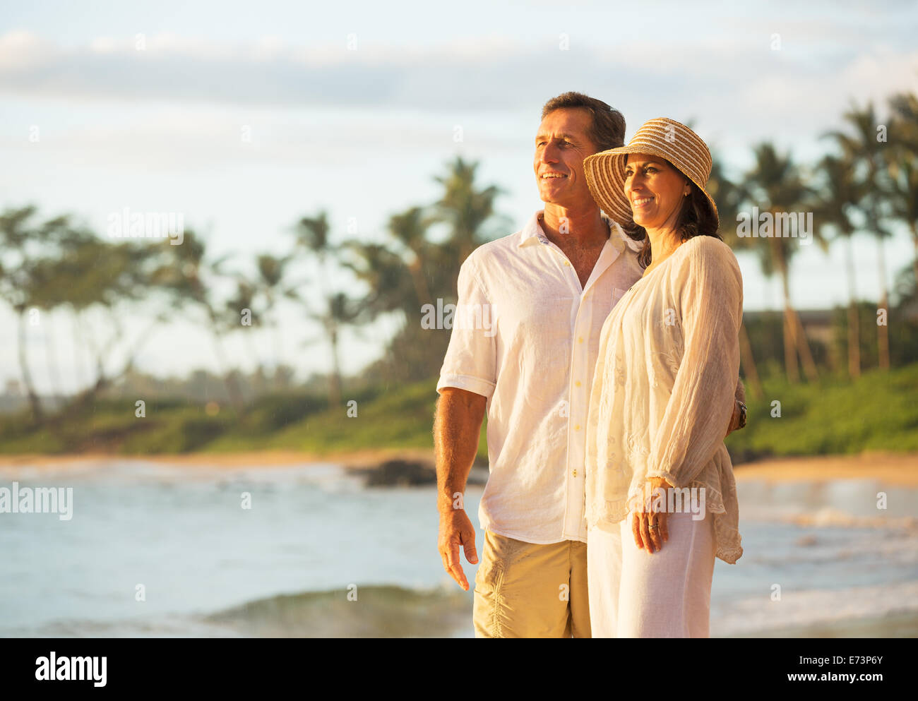 Mature Retired Couple Enjoying Sunset on Beach Vacation Stock Photo - Alamy