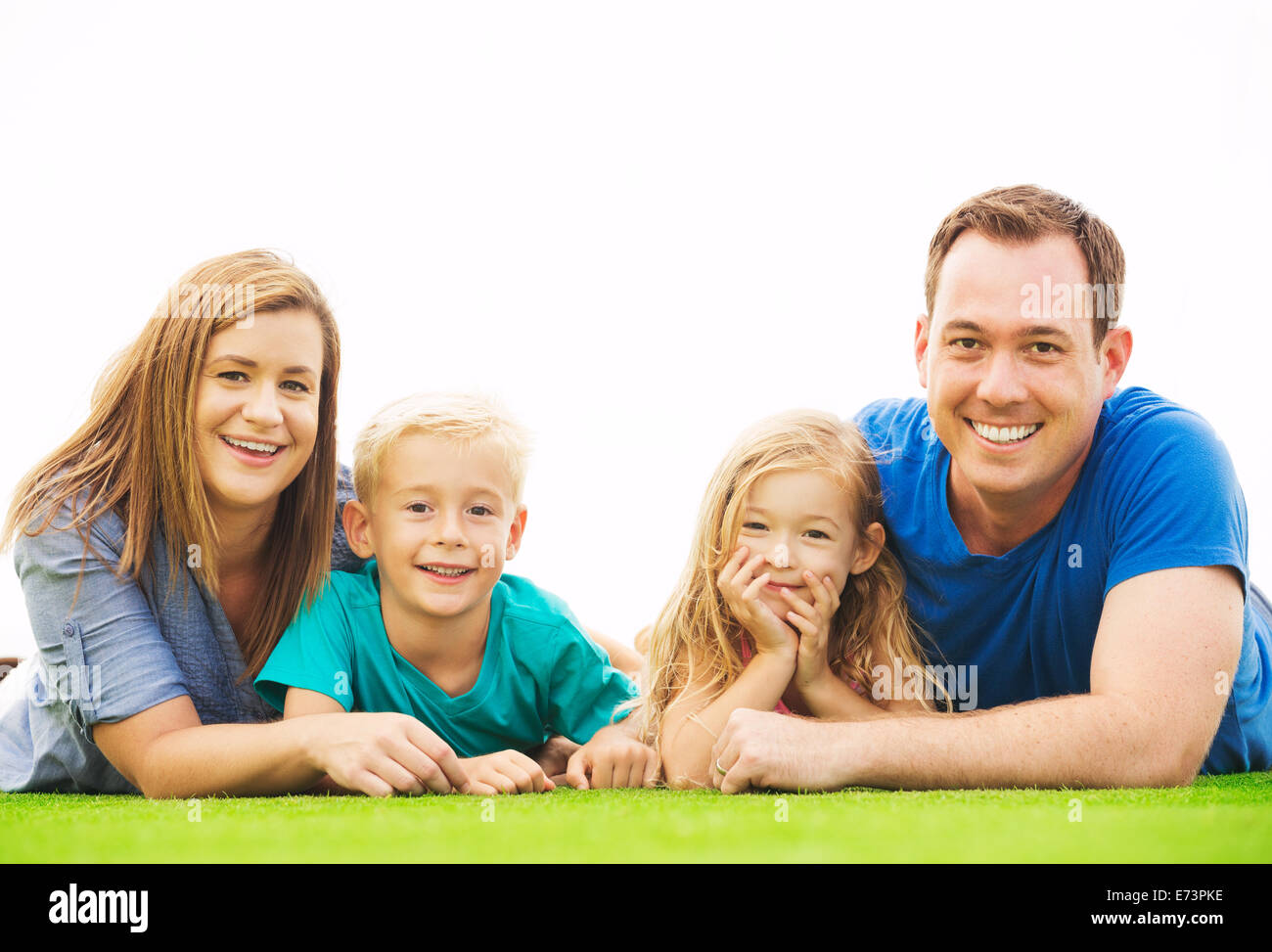 Portrait of Happy Family Outside on Grass Stock Photo - Alamy