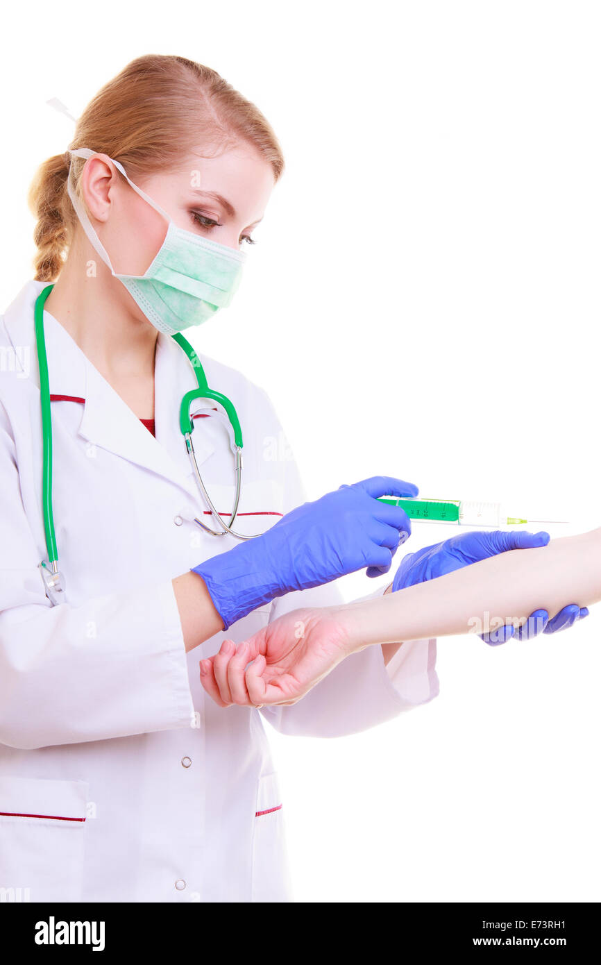 Female Hands of doctor or nurse with syringe giving injection to ...