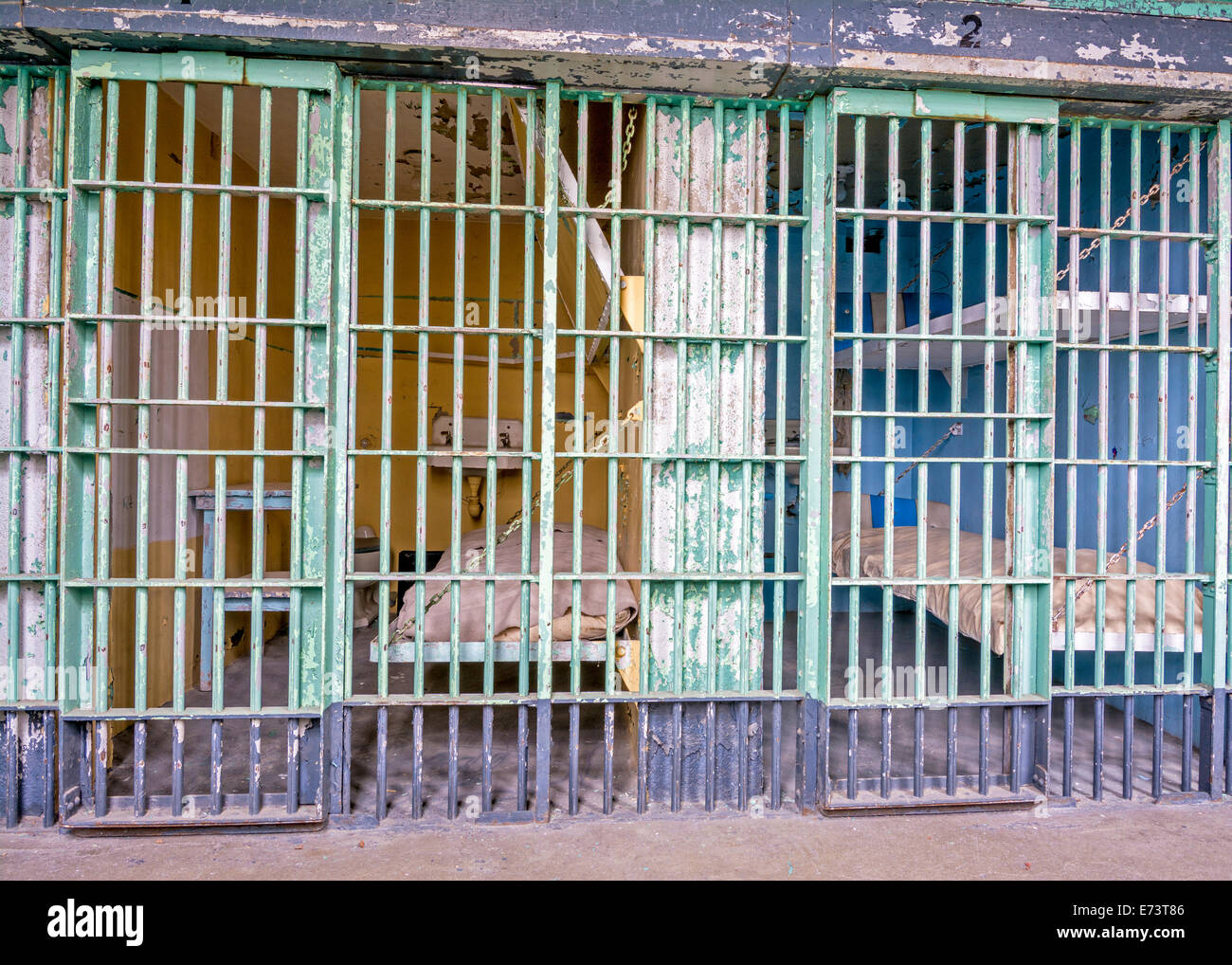 Old jail cells with paint peeling off bars Stock Photo - Alamy