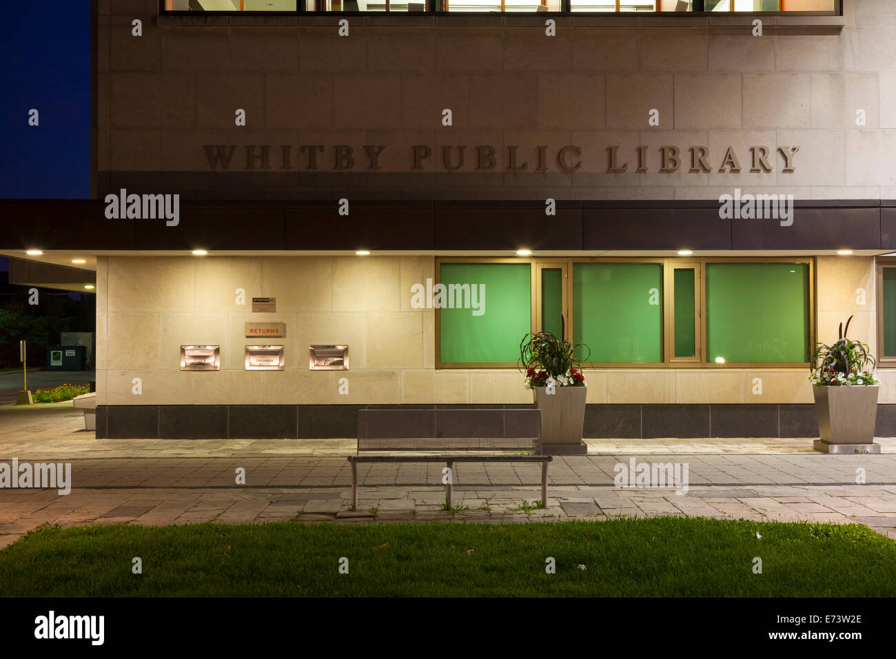 An entrance to the 'Whitby Public Library' including signage in ...