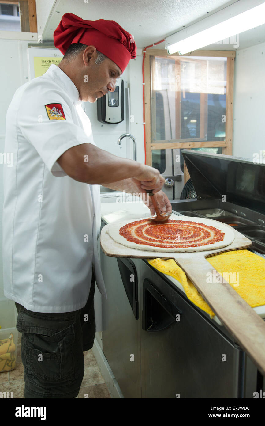 Chef at Italian restaurant making a pizza Stock Photo - Alamy