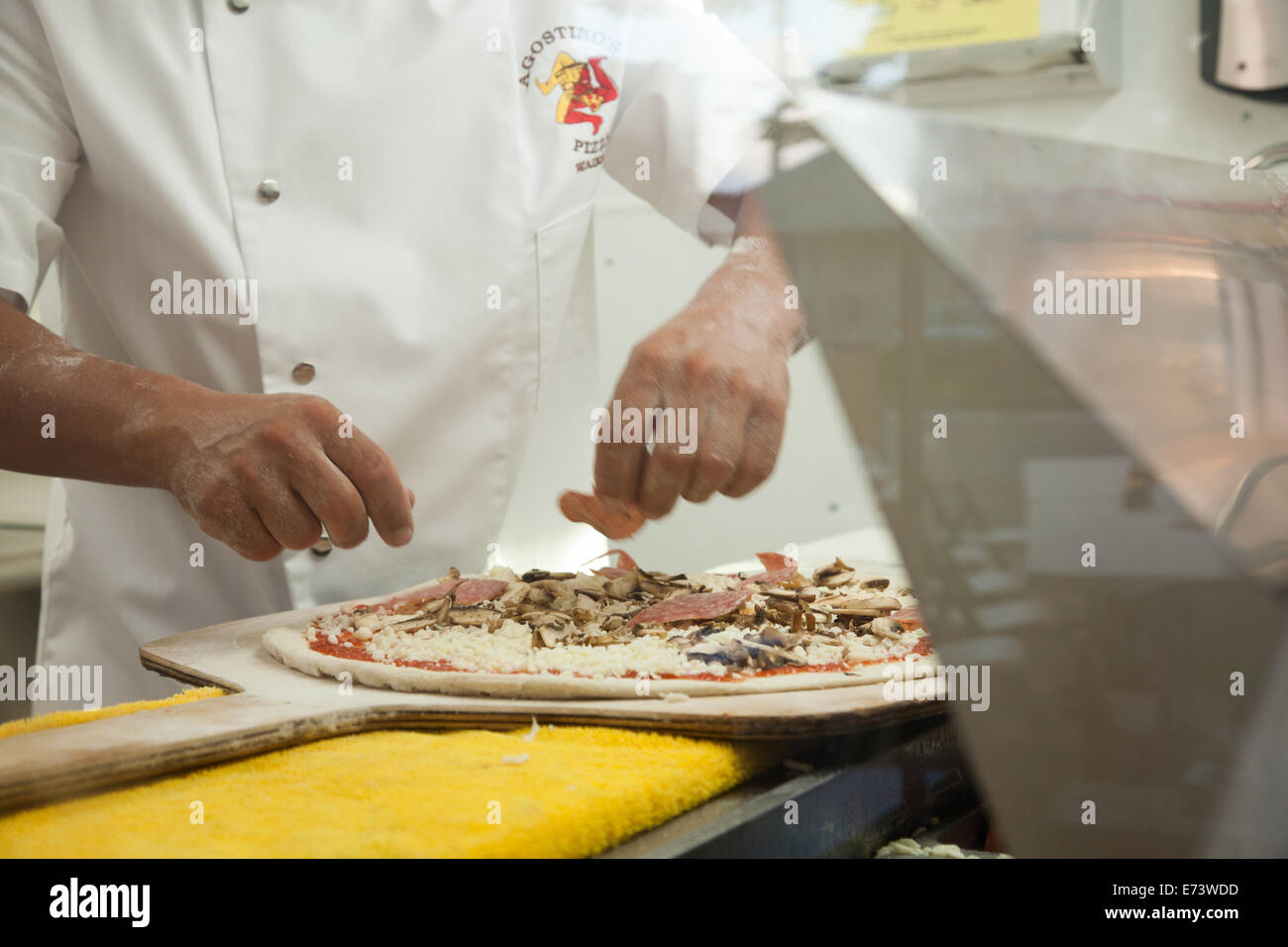 Chef at Italian restaurant making a pizza Stock Photo - Alamy