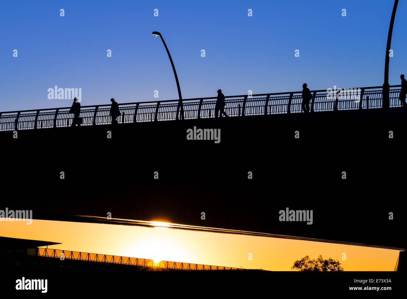 People walking over bridge Stock Photo - Alamy