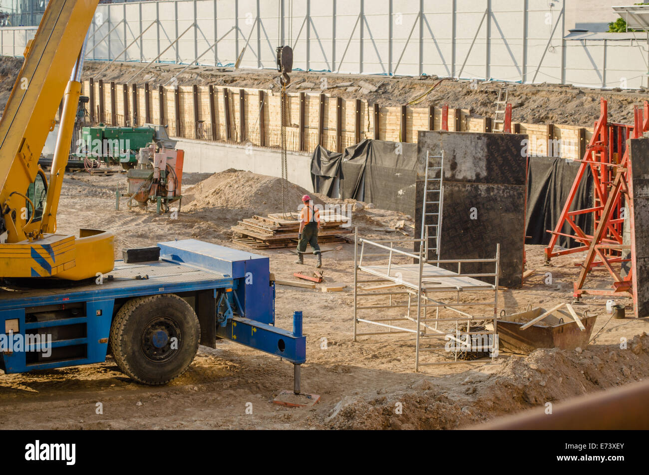 construction site with workers heavy machinery foundations handling and ...