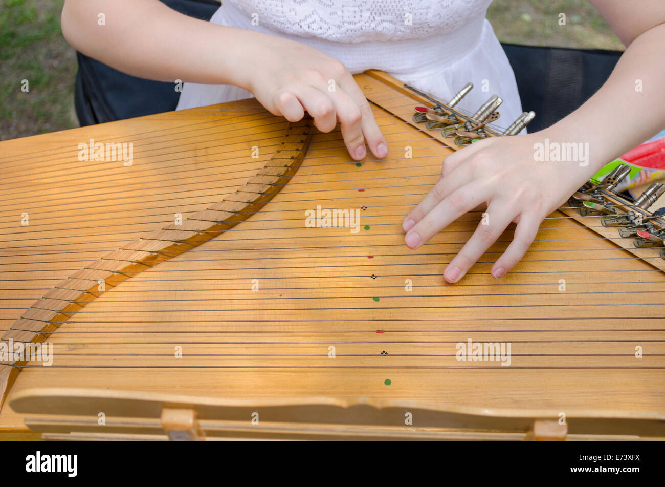 ancient wooden stringed traditional baltic psaltery and the girls hands ...