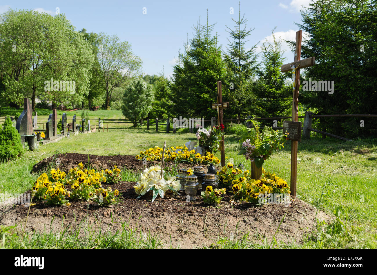 Freshly made grave soil flowers and foundation in cemetery Stock Photo ...
