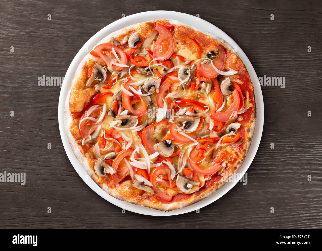 Italian pizza top view on wooden table Stock Photo - Alamy