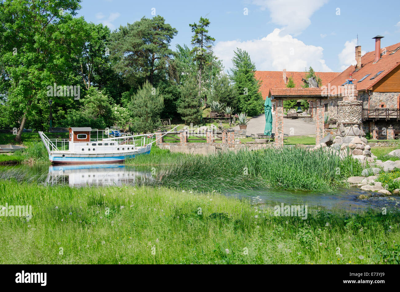 cruise wherry moored at the pier overgrown with grass near the ancient ...
