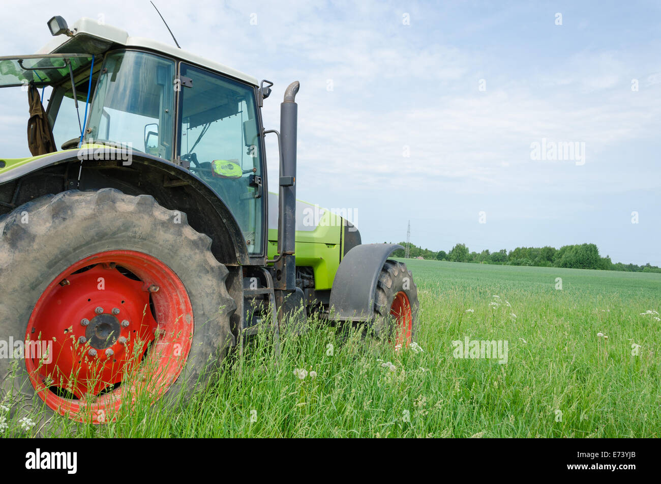 season of field work heavy equipment tractor stands in meadow Stock ...
