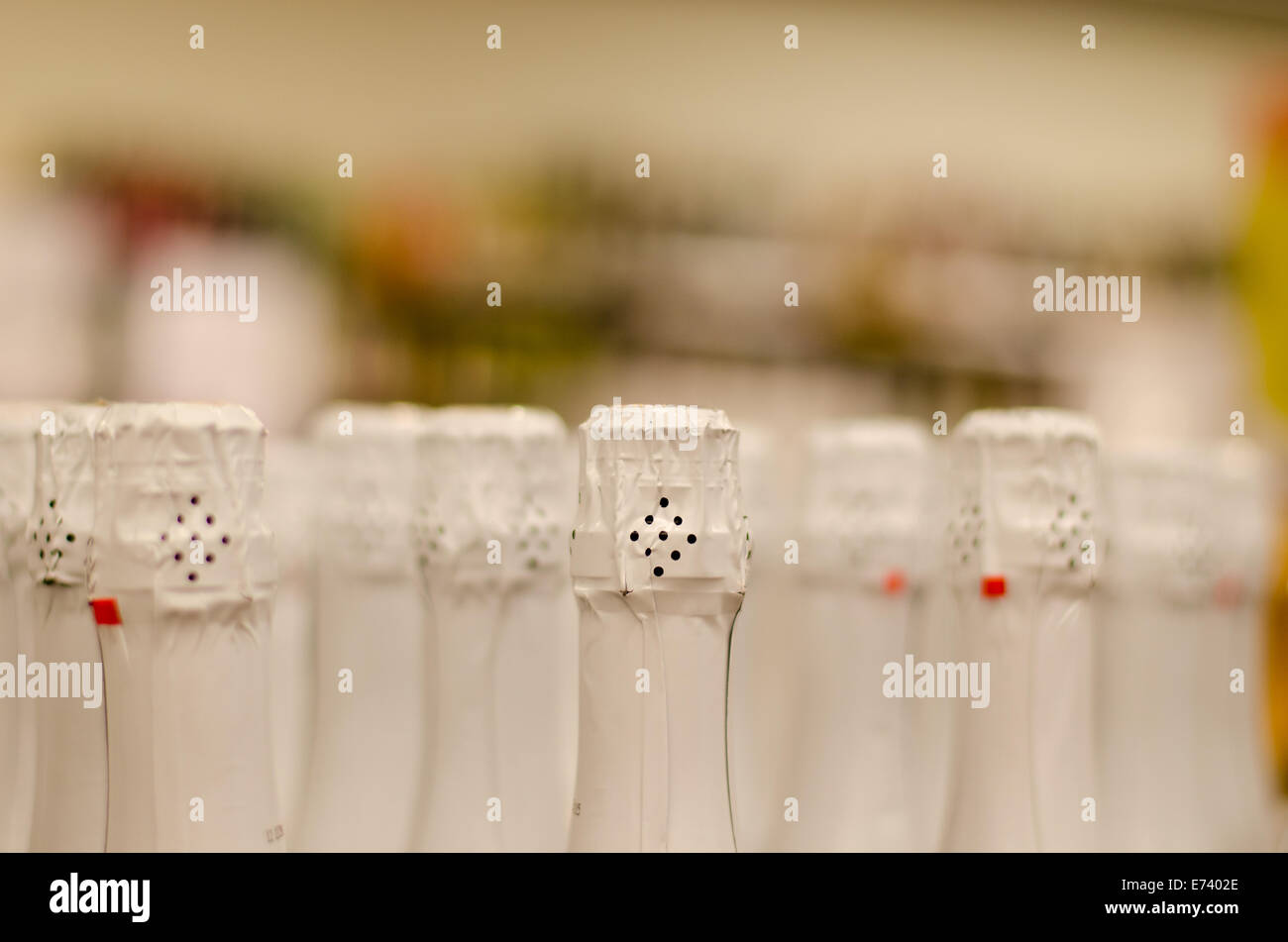 close up of champagne bottleneck with glossy white paper Stock Photo ...