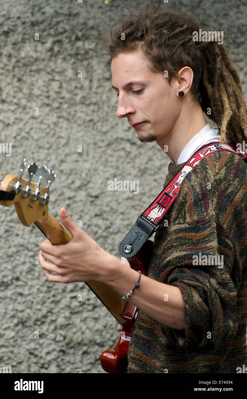 Bass guitarist with a band busking during the annual Festival Fringe in ...
