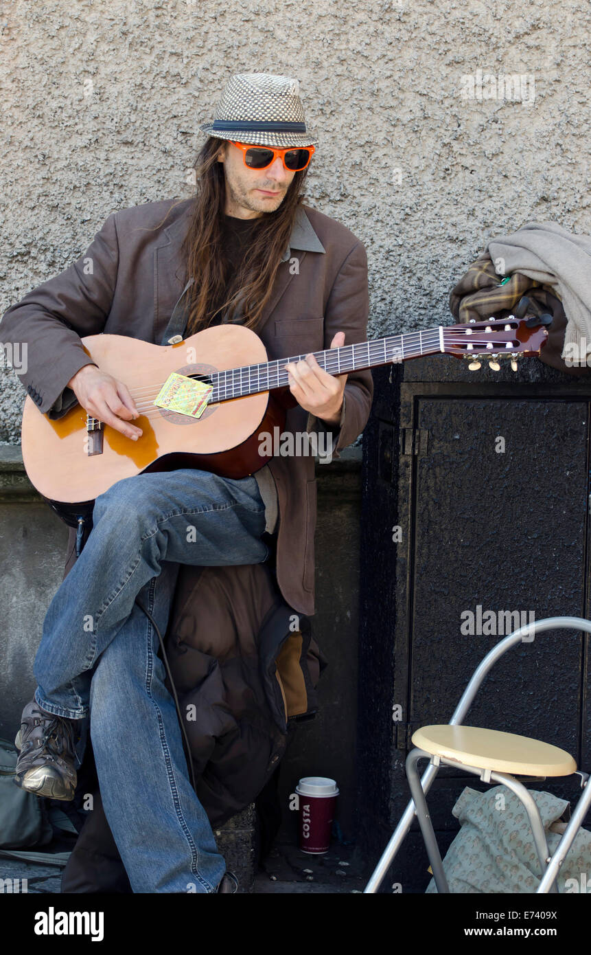 Guitarist with a band busking during the annual Festival Fringe in ...