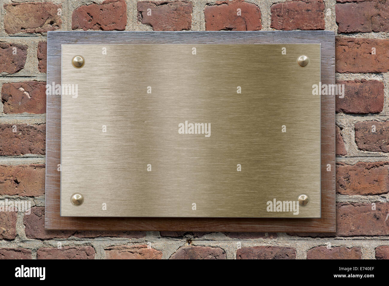 Brass or bronze metal plate on brick wall Stock Photo - Alamy