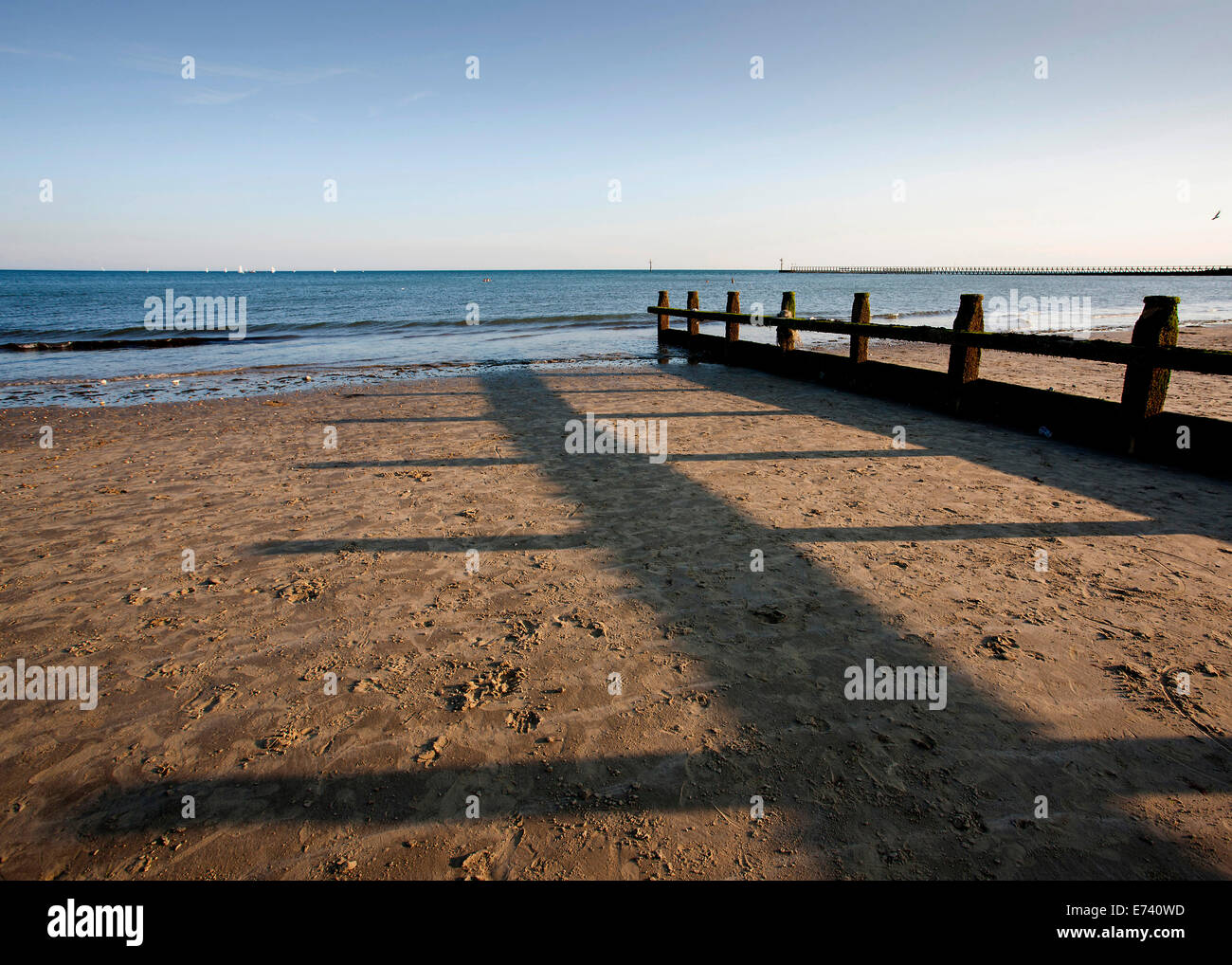 Wooden sea defences defenses evening shadow Stock Photo - Alamy