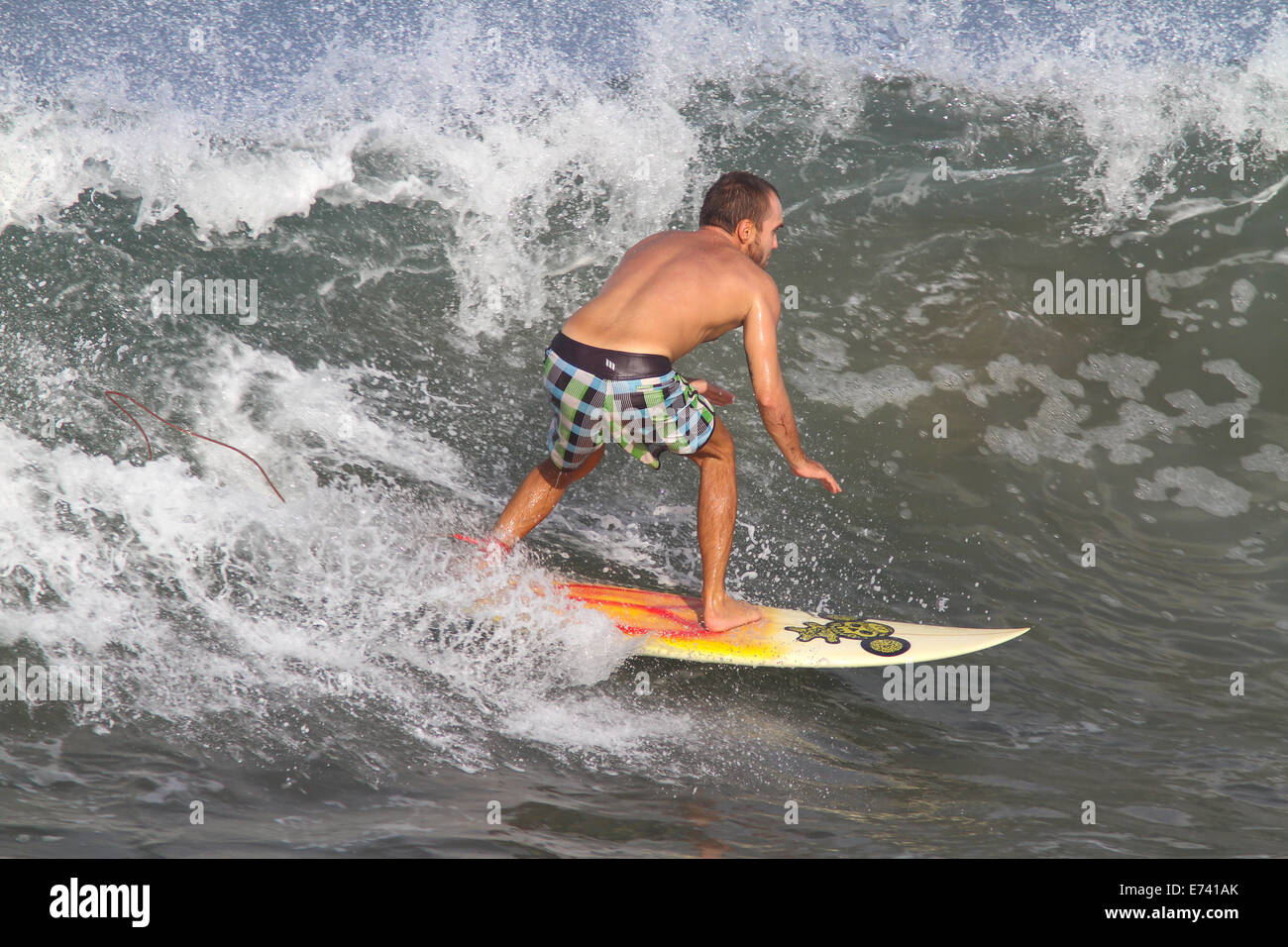 Surfing a wave Stock Photo - Alamy