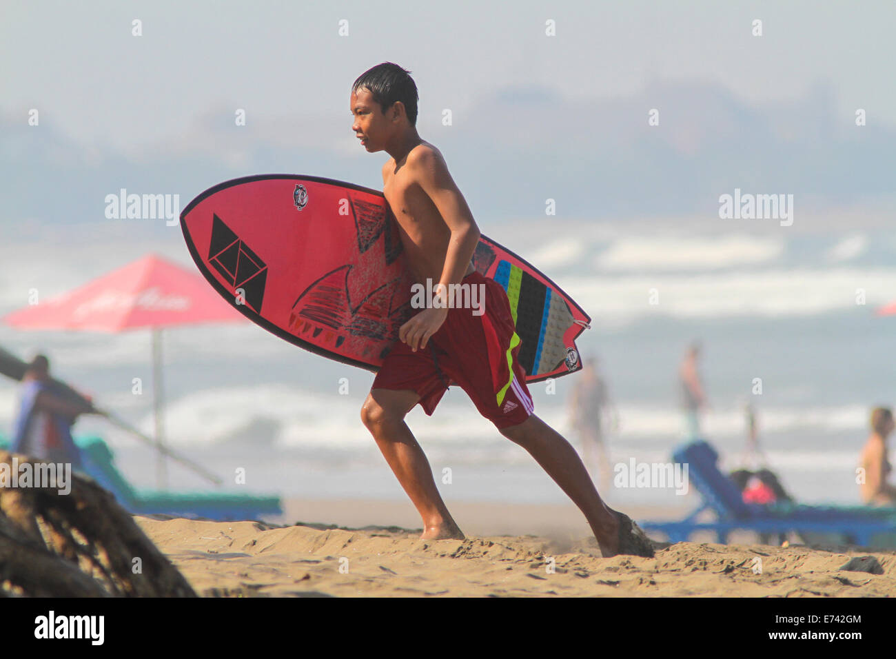 Surfer boy on the beach Stock Photo - Alamy