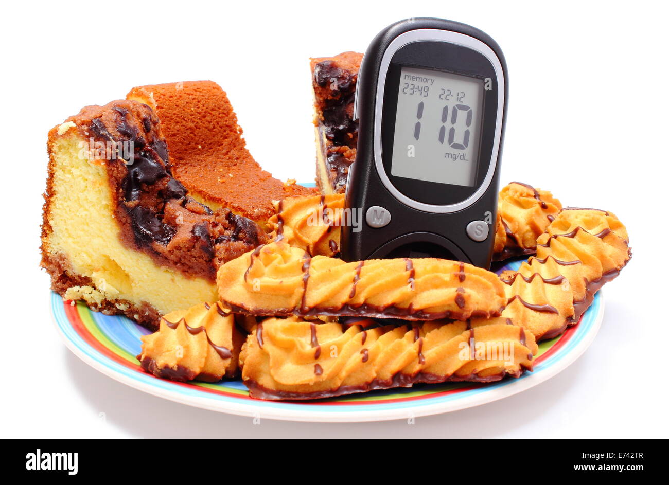 Fresh baked pastry and cakes on colorful plate and glucose meter ...