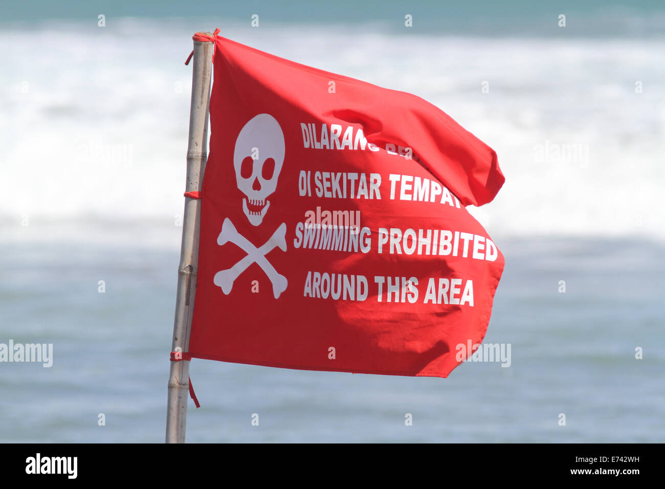 Red Flag on the Sand Beach with No Swimming Sign Stock Photo - Alamy