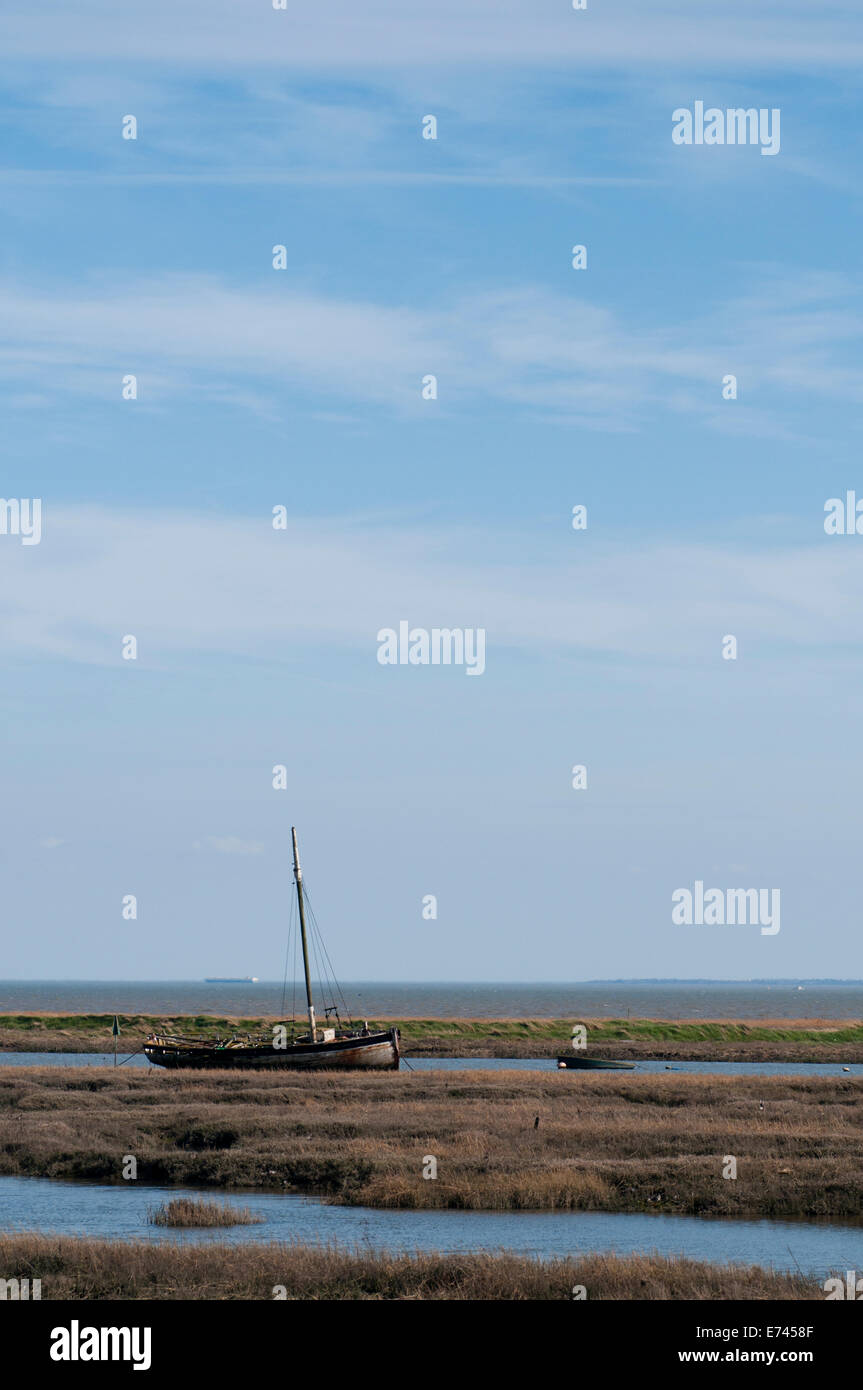 A single boat moored in the salt marsh at Leigh on Sea, Essex shot at ...
